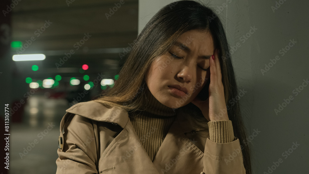 Sick Asian woman suffer headache in parking painful head migraine ache ...
