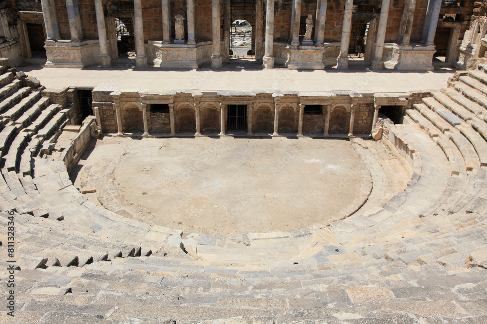 Ancient antique amphitheater, columns on the stage of the amphitheater ...