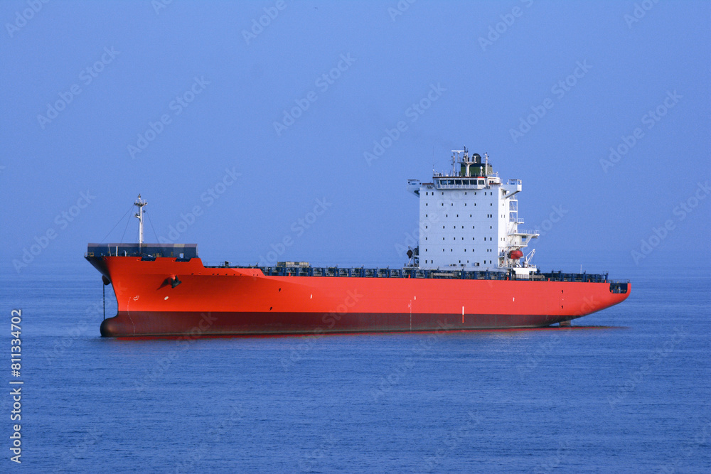 Container ship in ballast condition. Blue background of sea and sky ...