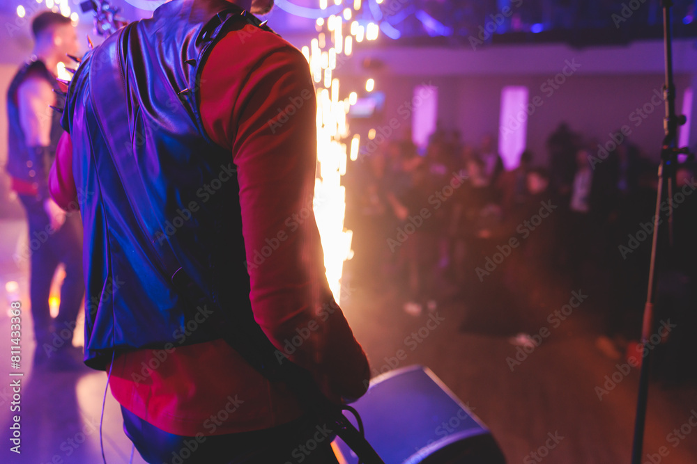 Concert view of an electric guitar player with vocalist and rock band ...