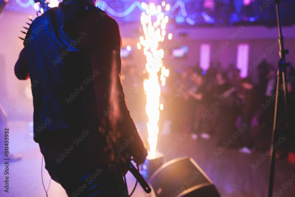 Concert view of an electric guitar player with vocalist and rock band ...