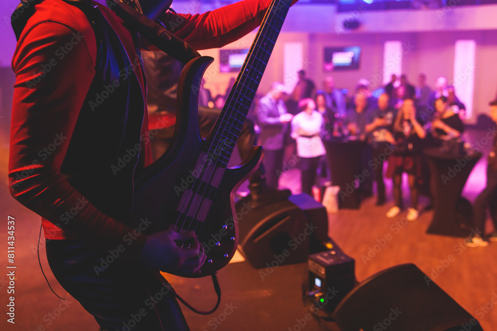 Concert view of an electric guitar player with vocalist and rock band ...
