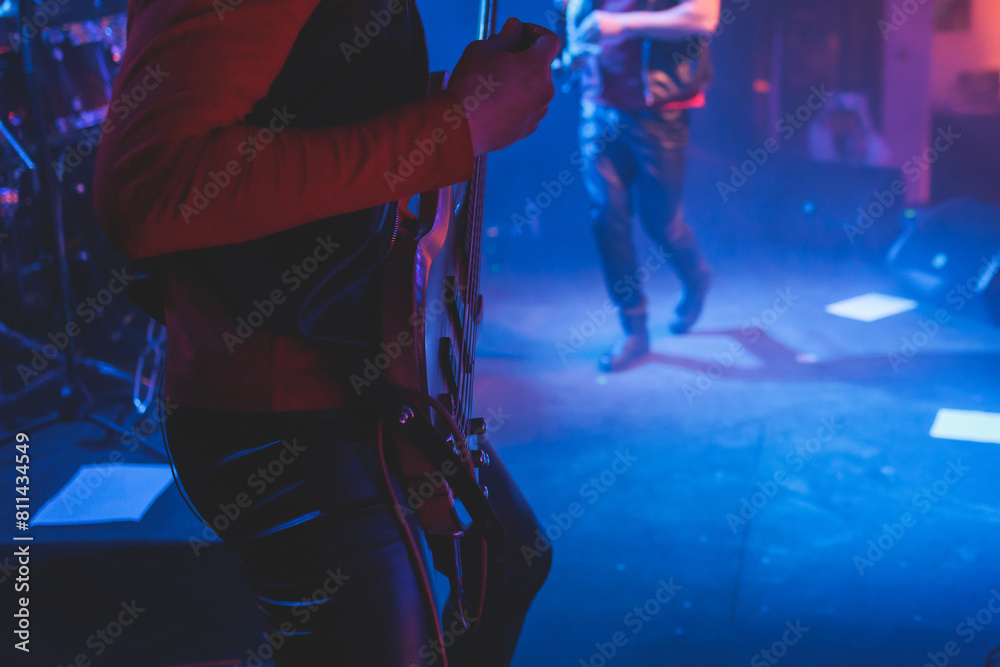 Concert view of an electric guitar player with vocalist and rock band ...