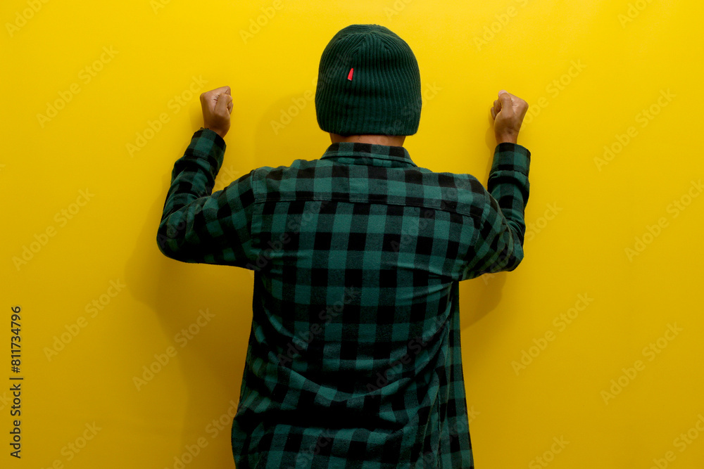 Knock-knock. Who's there? Back view of an excited young Asian man is ...