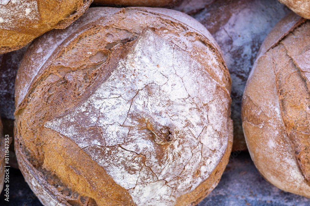 A close up of a piece of bread with a lot of flour on it. The bread is ...