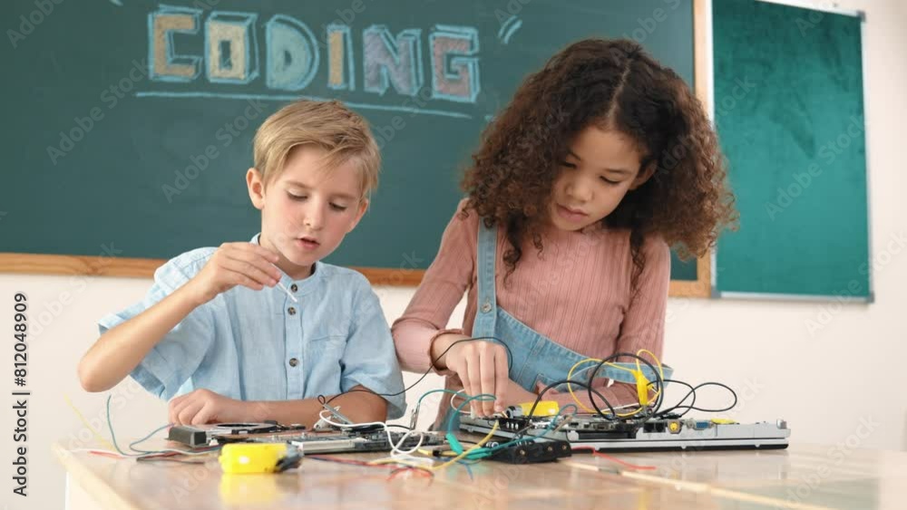 Girl standing while fixing electronic board by using screwdriver ...