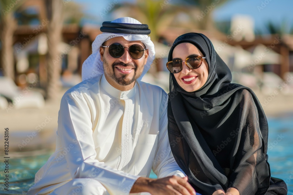 Joyful Muslim couple enjoying a sunny resort getaway, dressed in ...