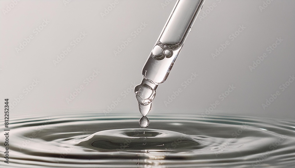 drop of facial serum or oil with bubbles pouring from transparent ...