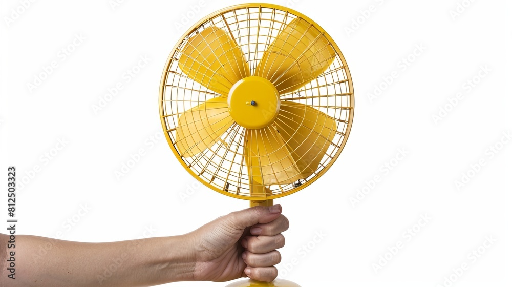 Hand grasping an electric Isolated yellow table fan against white ...