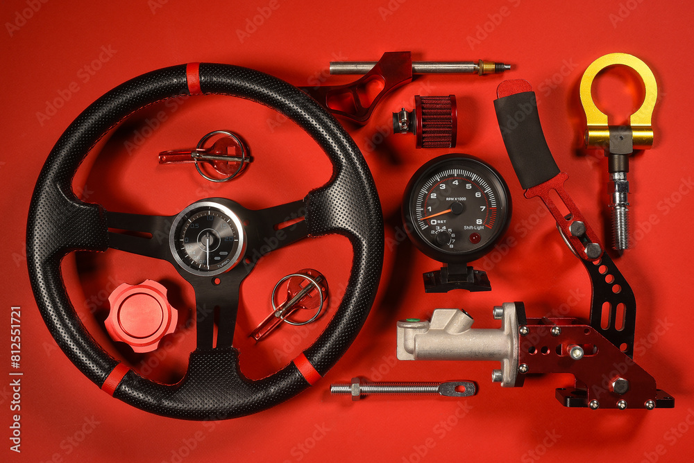 Sport car tuning equipment and spare parts on red top view background ...