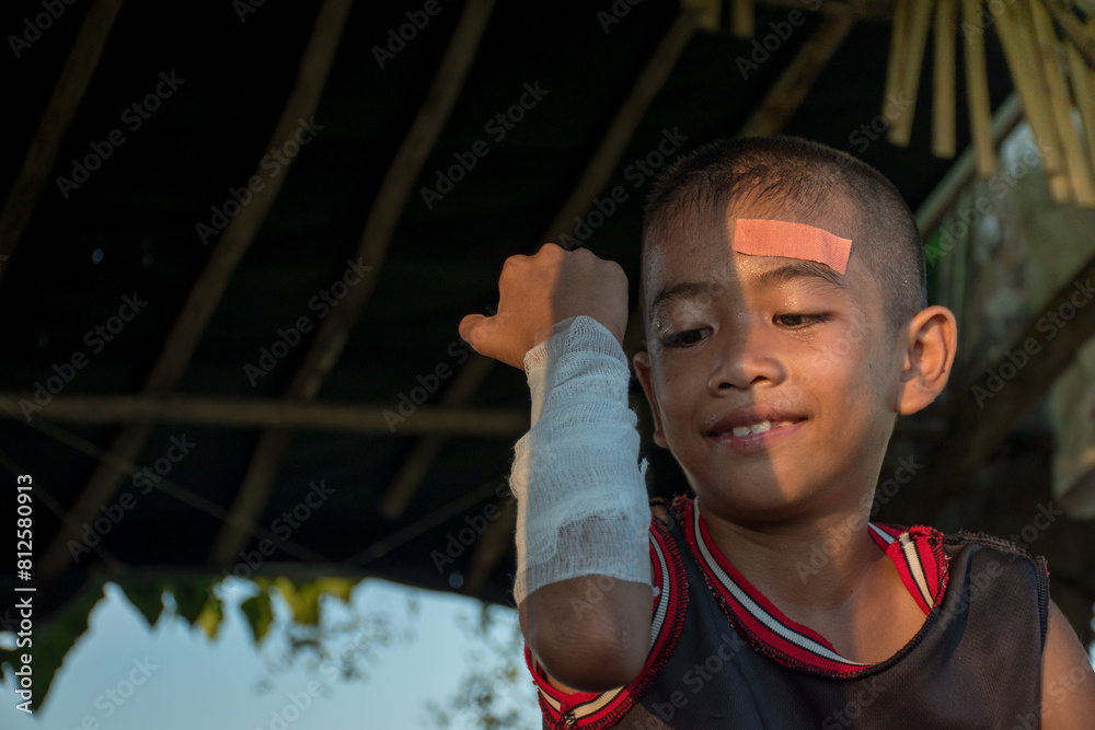 Plastic bandage on head and arm bandage wound Asian young boy cute ...