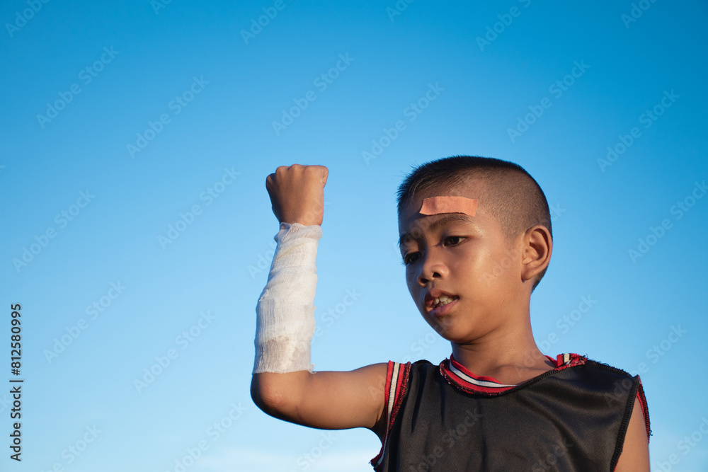 Plastic bandage on head and arm bandage wound Asian young boy smile and ...