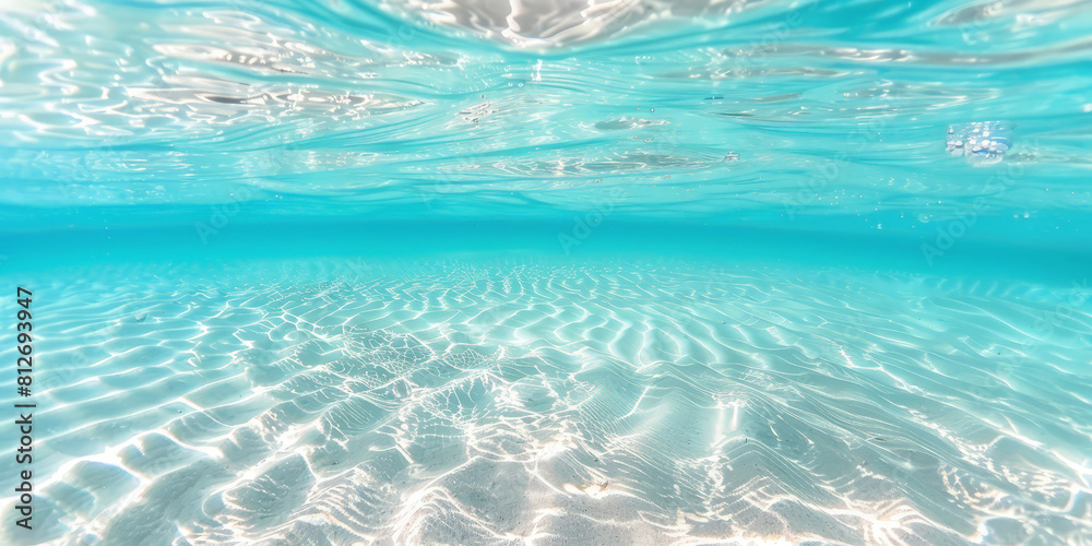 Underwater view of clear blue water, with light ripples and a white ...