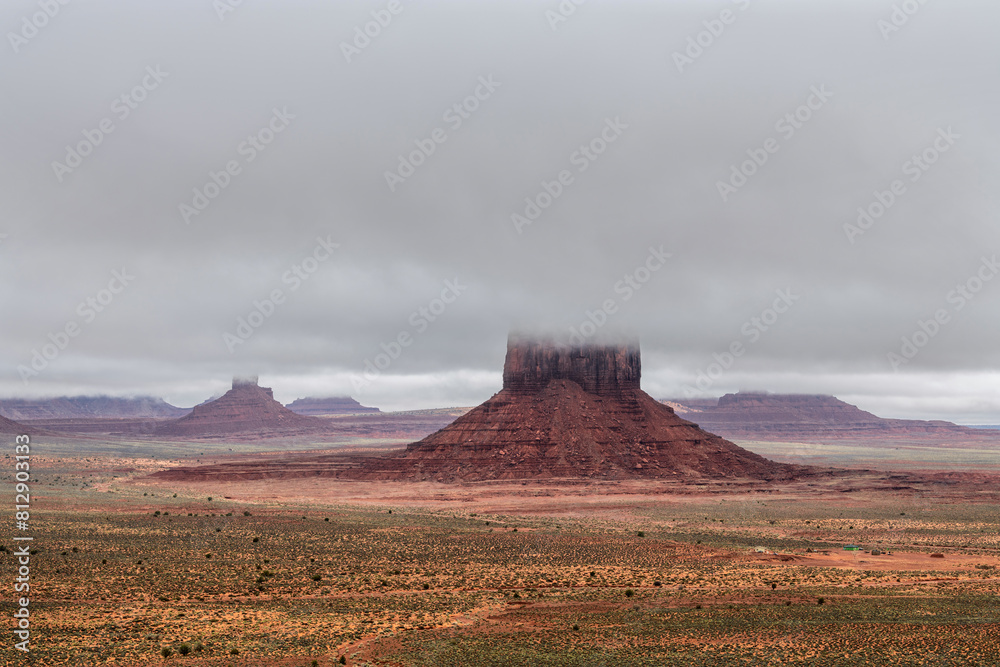 Monument Valley Buttes covered with low rain clouds during a gloomy day ...