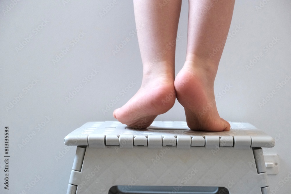 Baby feet. The baby stood on tiptoe. Baby feet on white background. A ...
