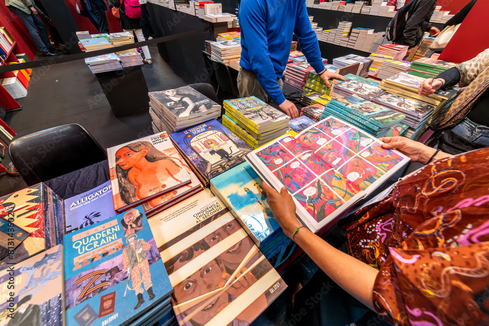 Turin, Italy - May 10, 2024: Woman hands flipping through comic book ...