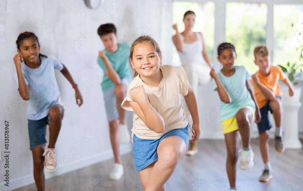 Positive female child dances vogue in choreographic school. Group of ...