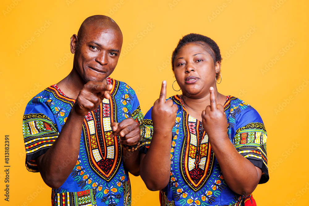 Black man and woman couple showing middle finger offensive gesture ...