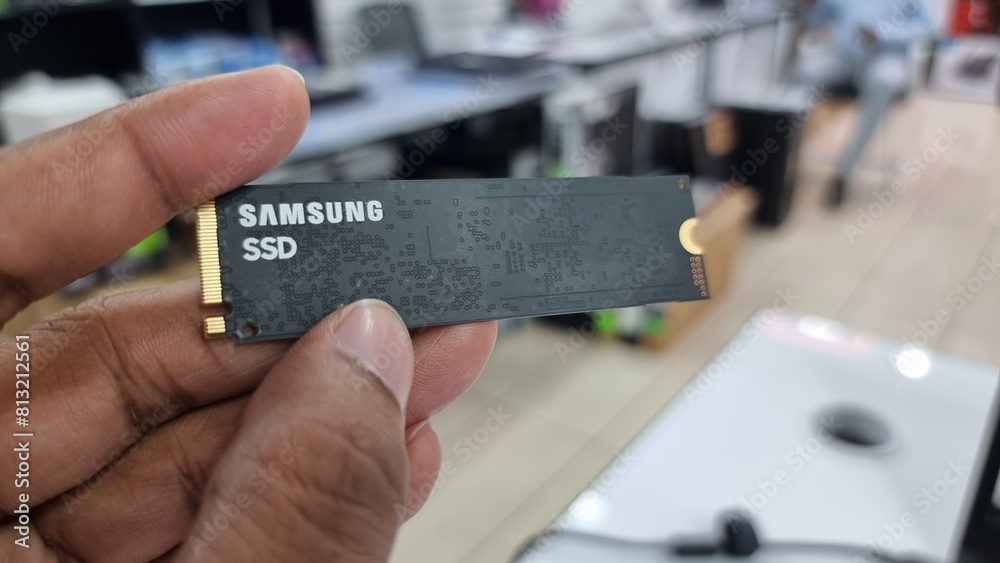 Male Hand holding a Samsung PM9A1 Gen4x4 512GB NVMe SSD, is a South ...