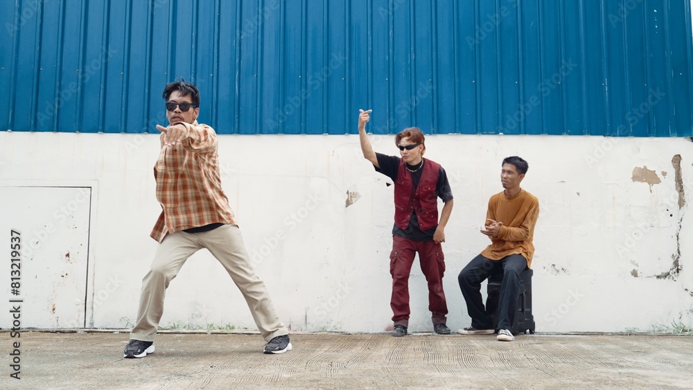 Young street dancer dancing in hip hop style with multicultural friends ...