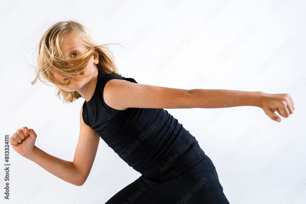 Young boy athlete in a black track outfit running in a race with his ...