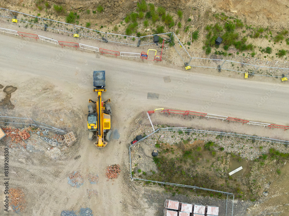 Drone top down view of a yellow low loader vehicle seen with an empty ...