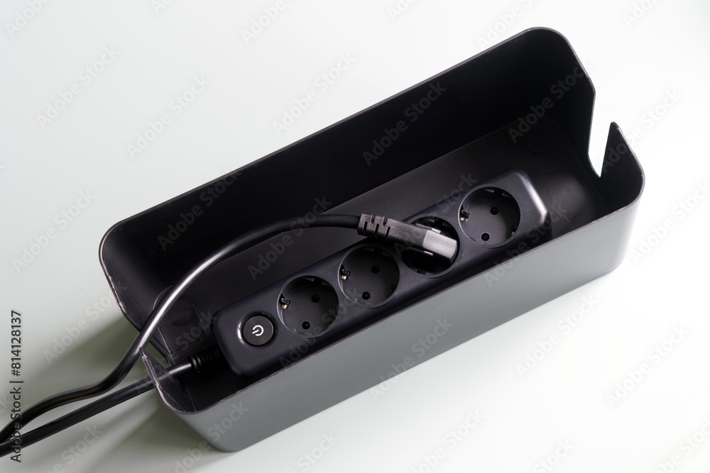 An electrical extension cord with four sockets and connected electrical ...