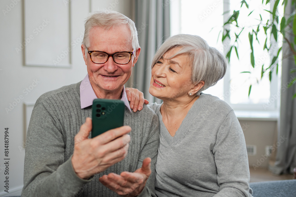 Video call. Happy senior couple woman man with smartphone having video ...