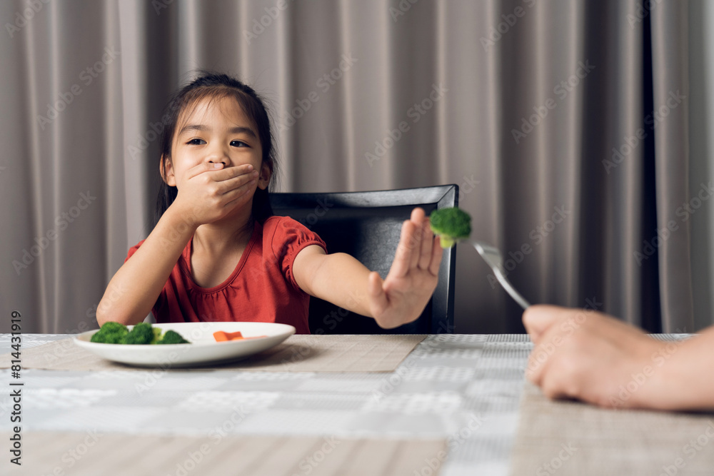 Little cute kid girl refusing to eat healthy vegetables. Children do ...