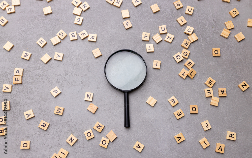 Magnifying glass with many wood letters of English alphabets, learning ...