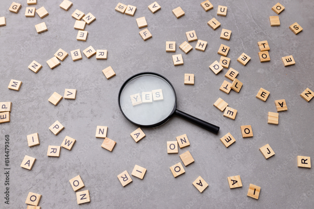 Magnifying glass with many wood letters of English alphabets and word ...
