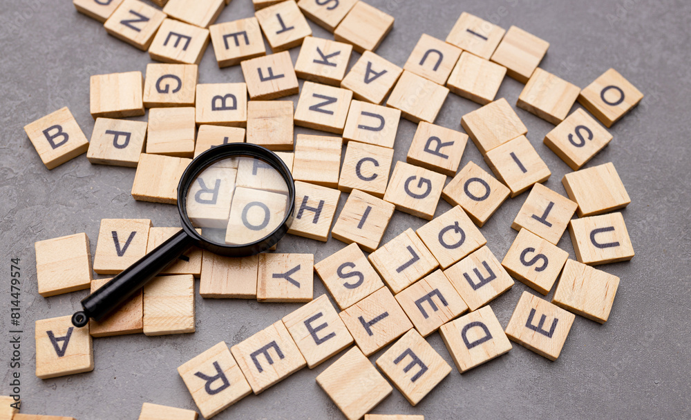 Magnifying glass with many wood letters of English alphabets, learning ...