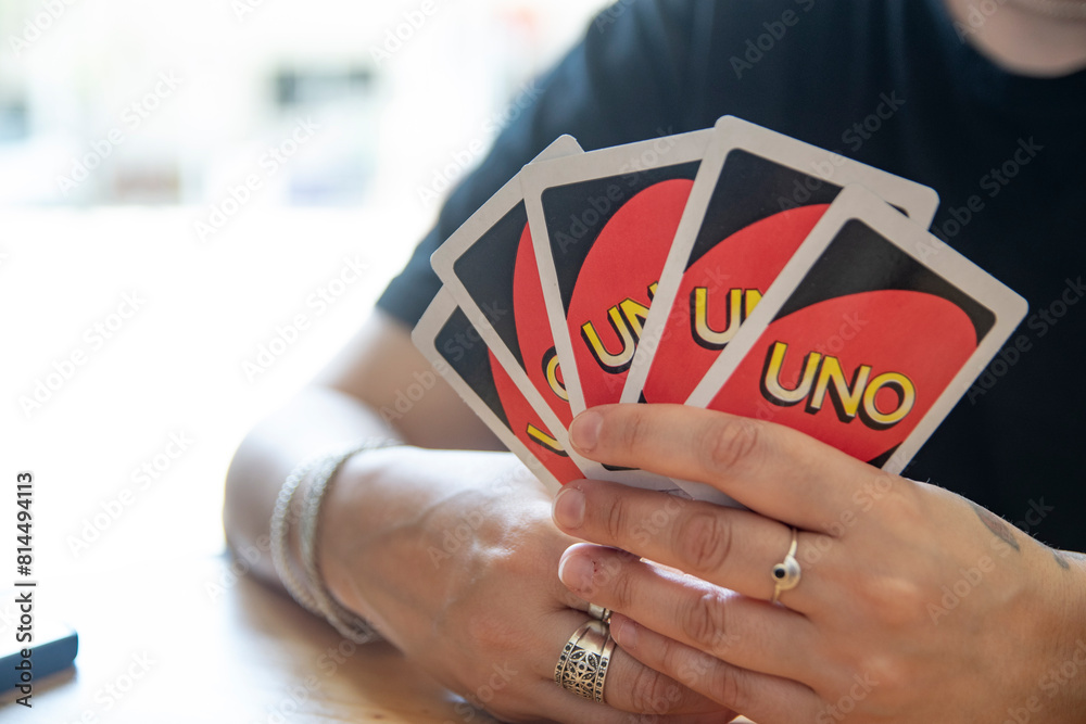 Barcelona, April 5th 2024: Girl holding cards of UNO game in a play ...