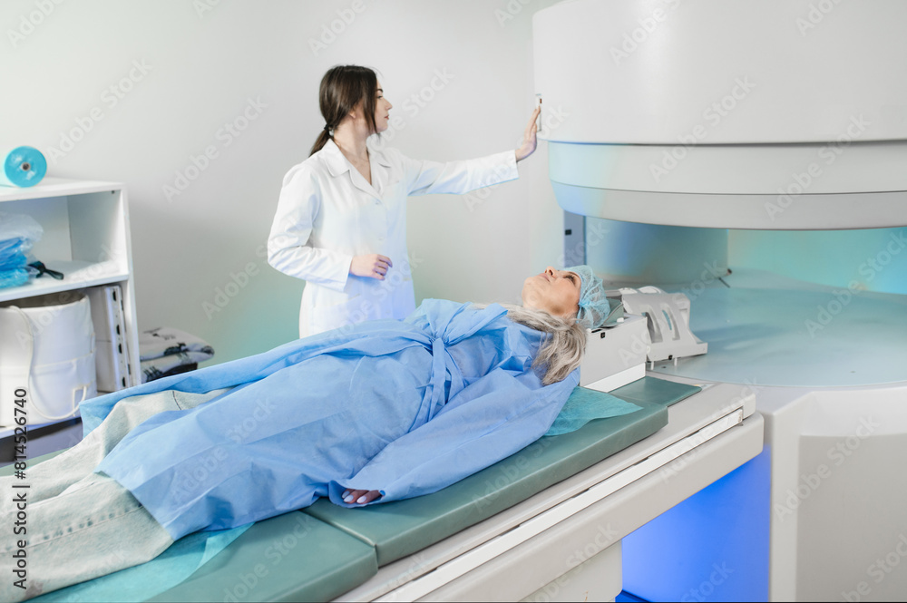 Woman doctor and patient in the MRI room. female assistant preparing ...