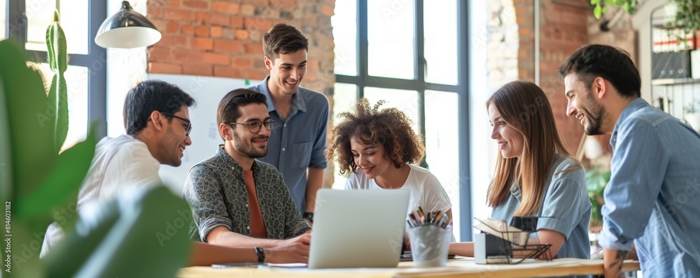 A diverse team of young adults engaging in a meeting with a laptop in a ...