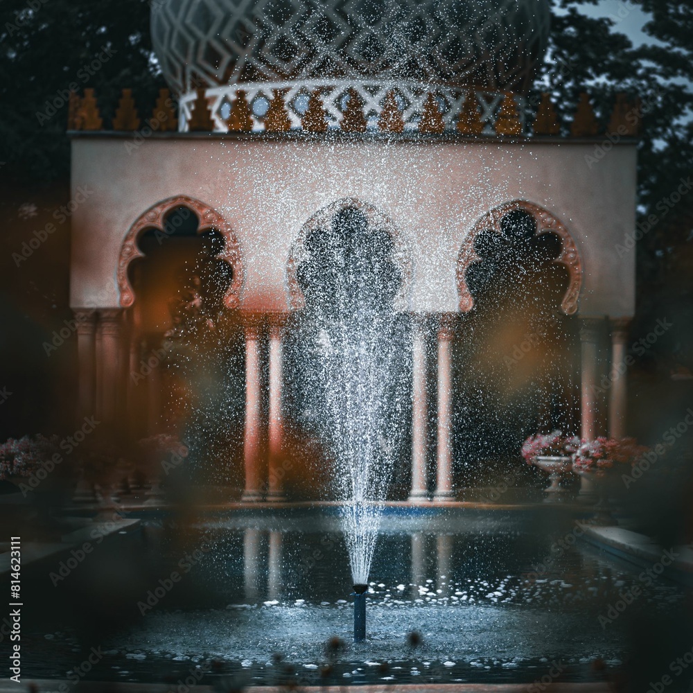 water fountain inside a white walled building next to two pillars Stock ...