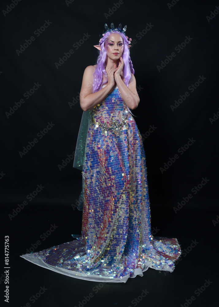 Full length portrait of beautiful female model with long purple hair ...