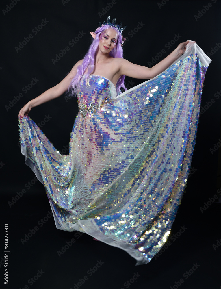 Full length portrait of beautiful female model with long purple hair ...