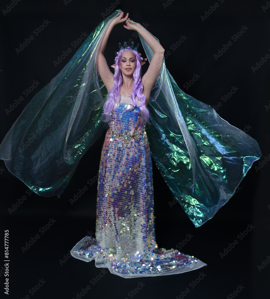 Full length portrait of beautiful female model with long purple hair ...