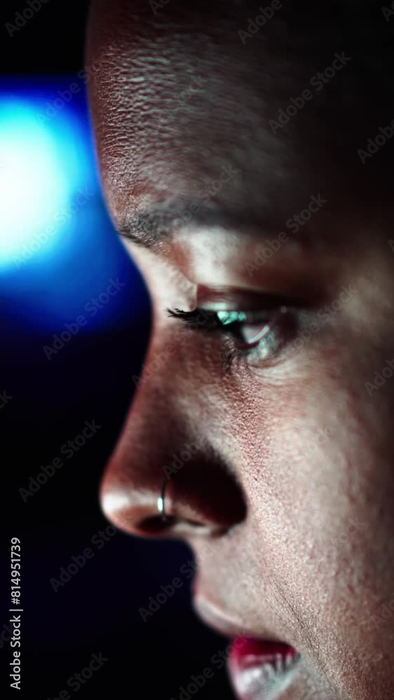 Vertical Close up young black woman indoors looking at screen making ...