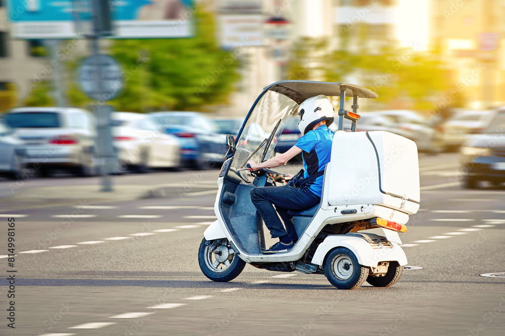 Delivery man riding on electric scooter, deliver food. Food delivery ...
