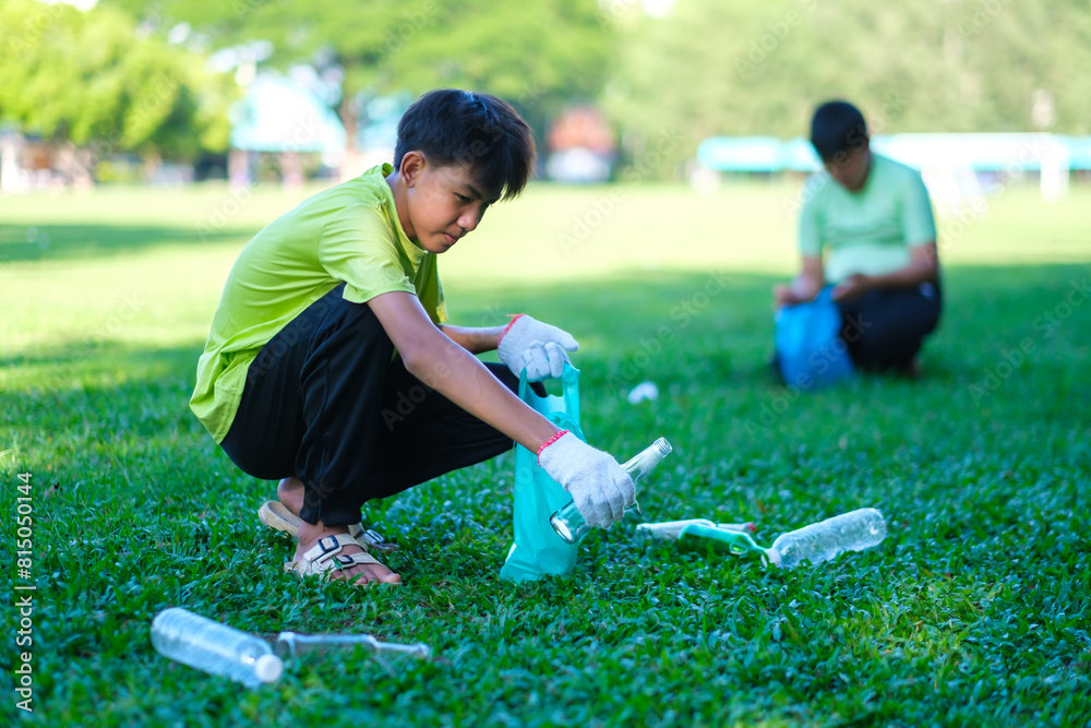 Teenagers picking up water bottles of trash cleaning up school yards ...