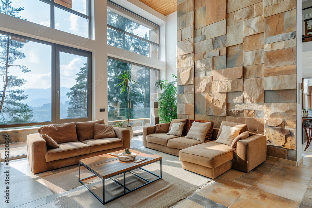 Brown sofas against stone tiles cladding wall in room with high ceiling ...