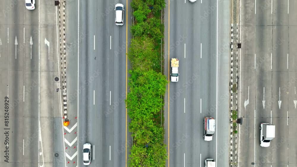 From above, a bustling thoroughfare unfolds, a symphony of motion. Cars ...