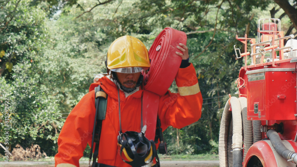 Fireman prepare equipment at fire engine truck. Man hand connect water ...