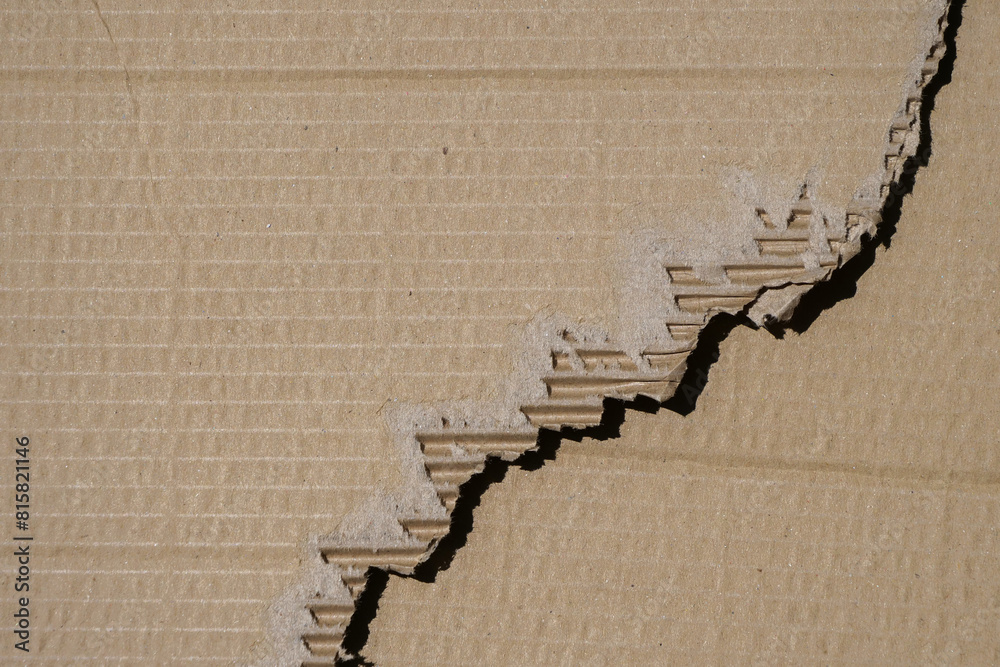 Old textured cardboard sheet with torn edges on brown cardboard texture ...