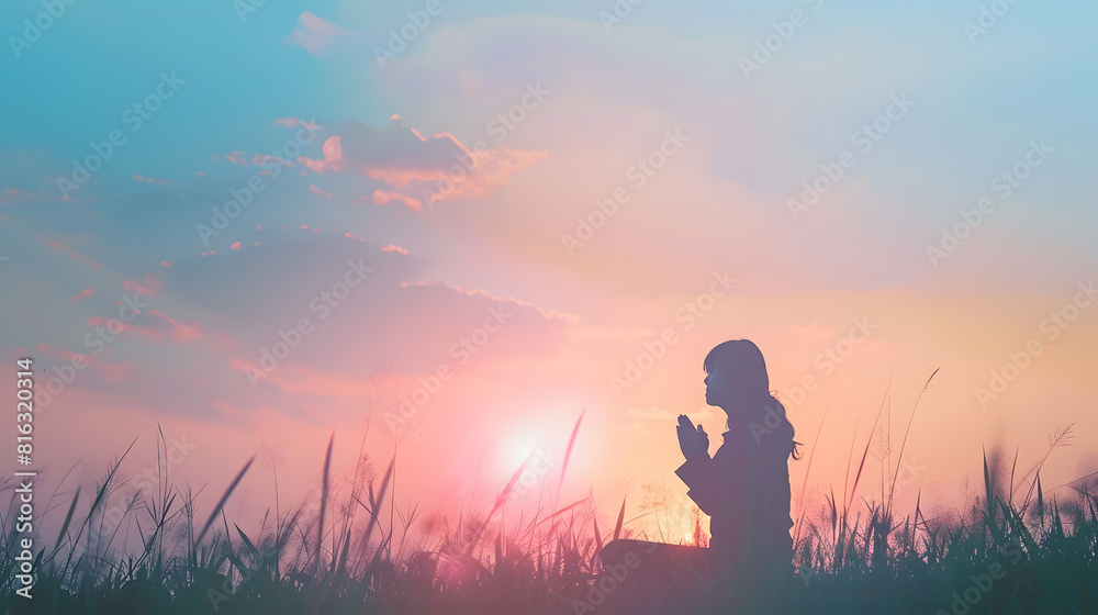 Silhouette of woman kneeling down praying for worship God at sky ...