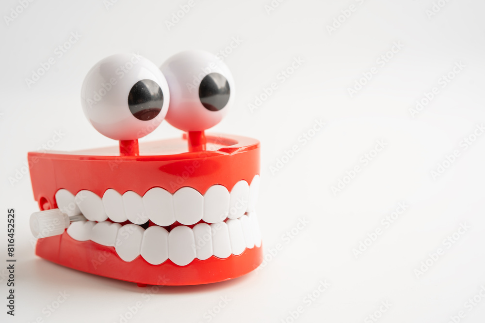 Tooth funny toy denture red color jaw and eye on whtie backgroud with ...