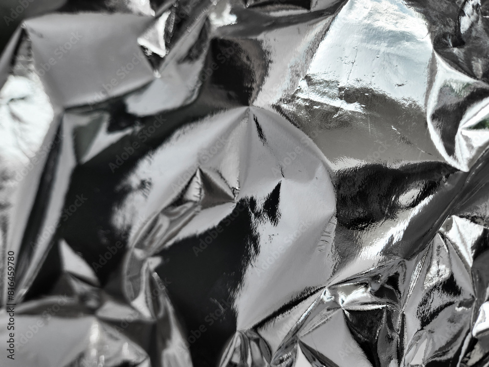 Thin sheet of silver leaf background with shiny crumpled uneven surface ...