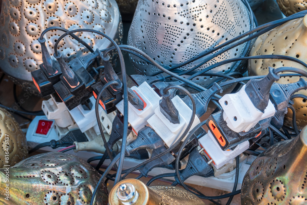 Old and damaged electric adapter power plug has many appliances are ...